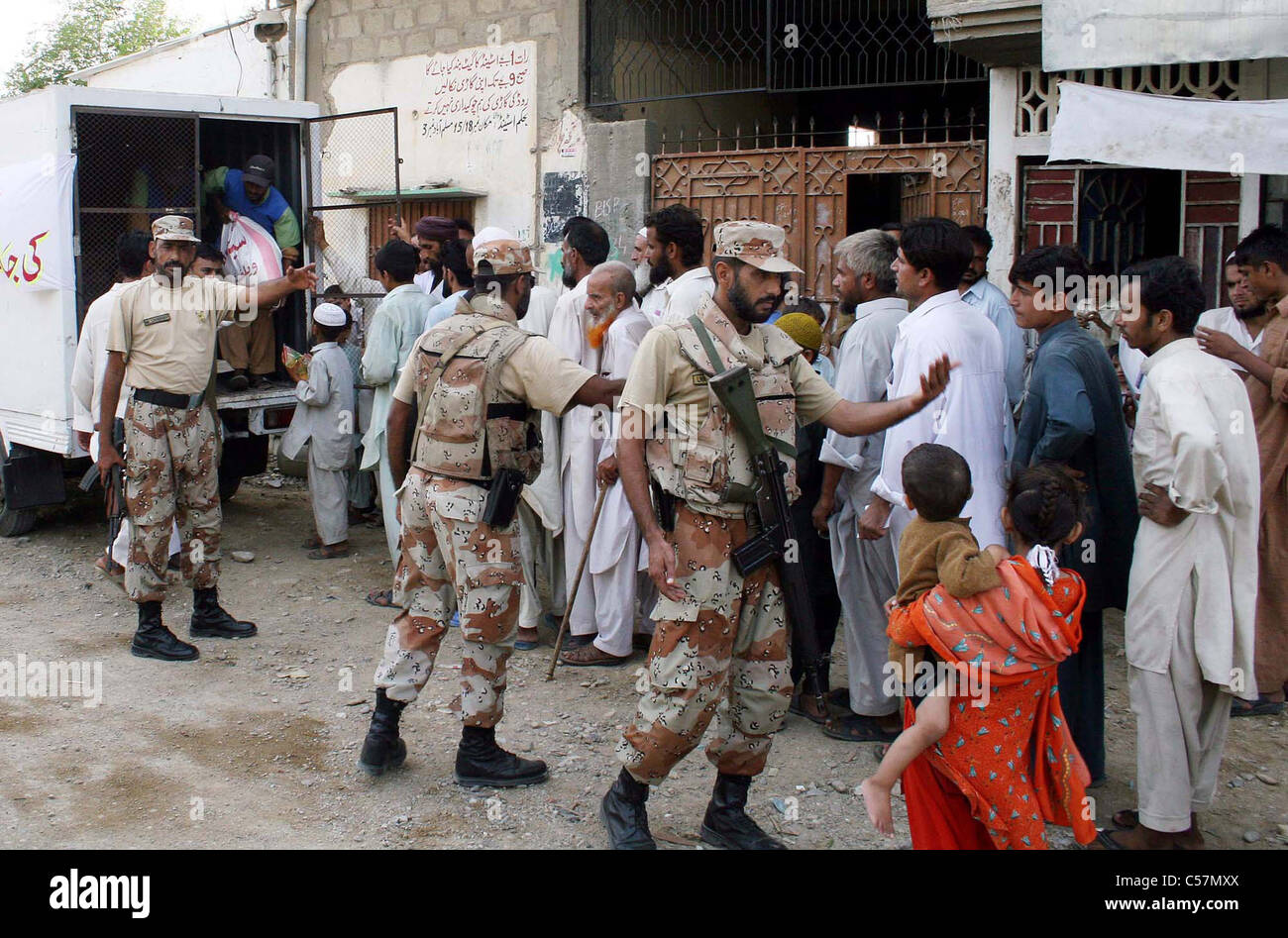 Rangers soldiers arrange queue while volunteers of Saylani Welfare ...