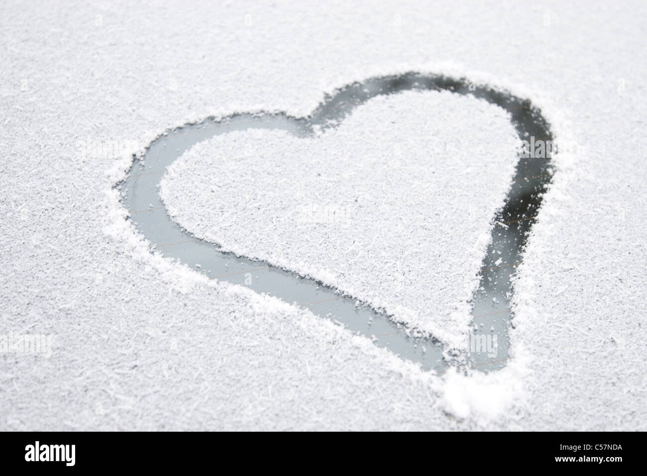 Heart shape drawn on white snow, love symbol for Valentine Day ...