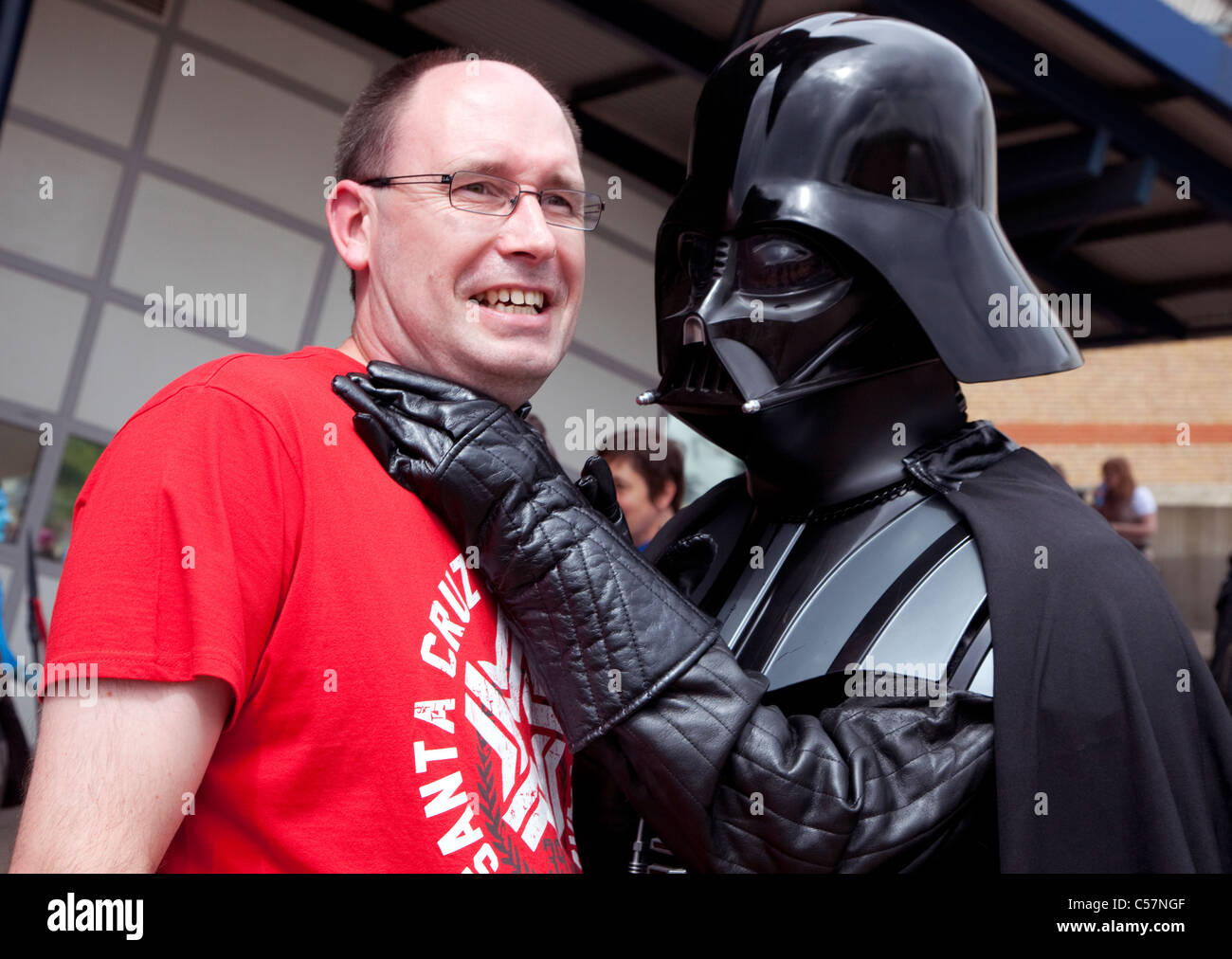 London Film & Comic Con 2011: Darth Vader character with visitor Stock ...