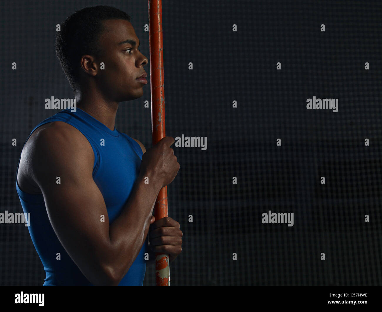 Runner holding pole Stock Photo - Alamy