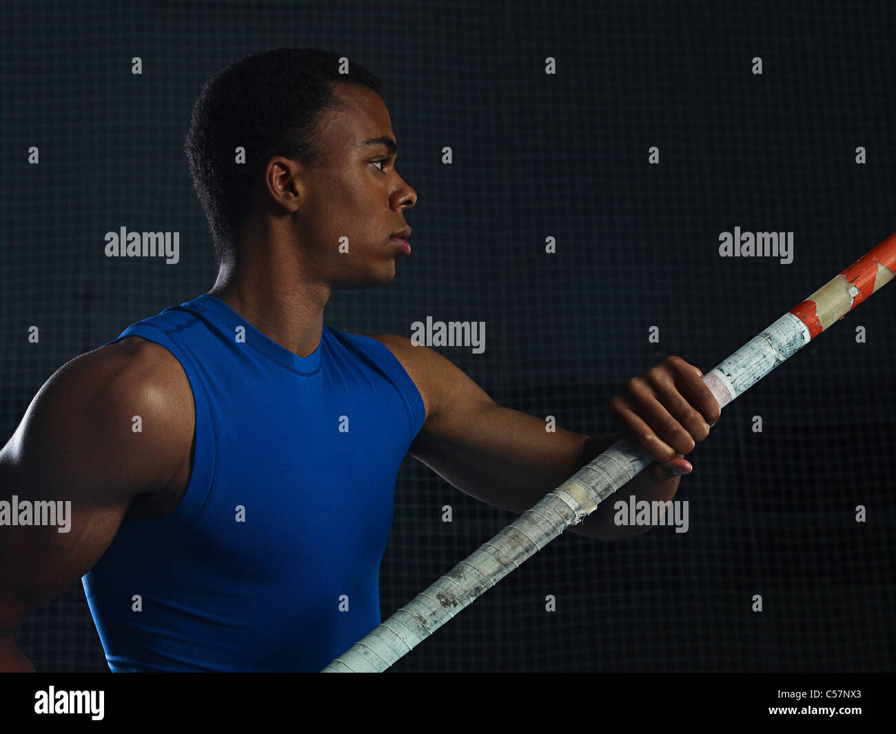 Runner holding pole Stock Photo - Alamy