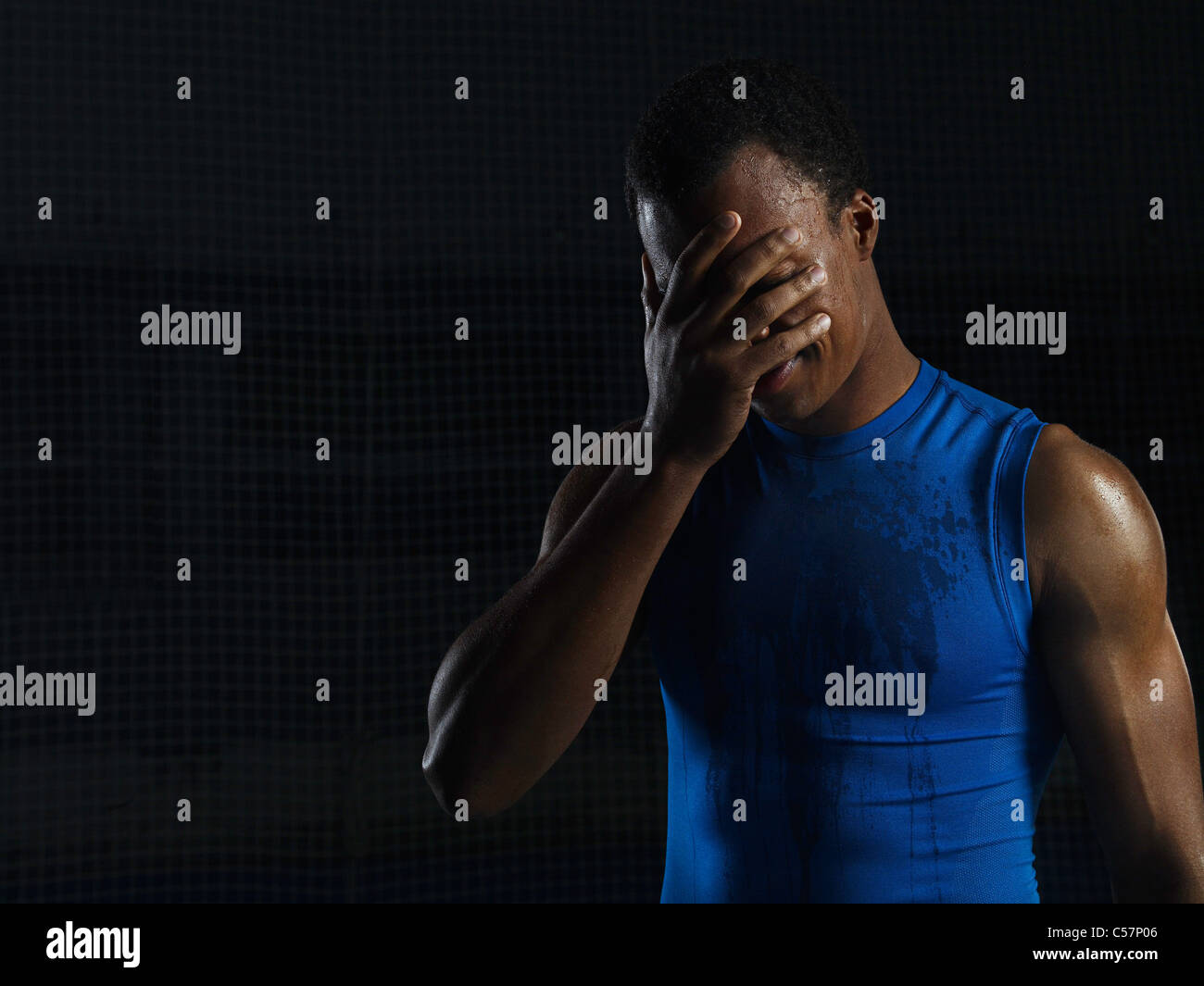 Runner holding face in hand Stock Photo - Alamy