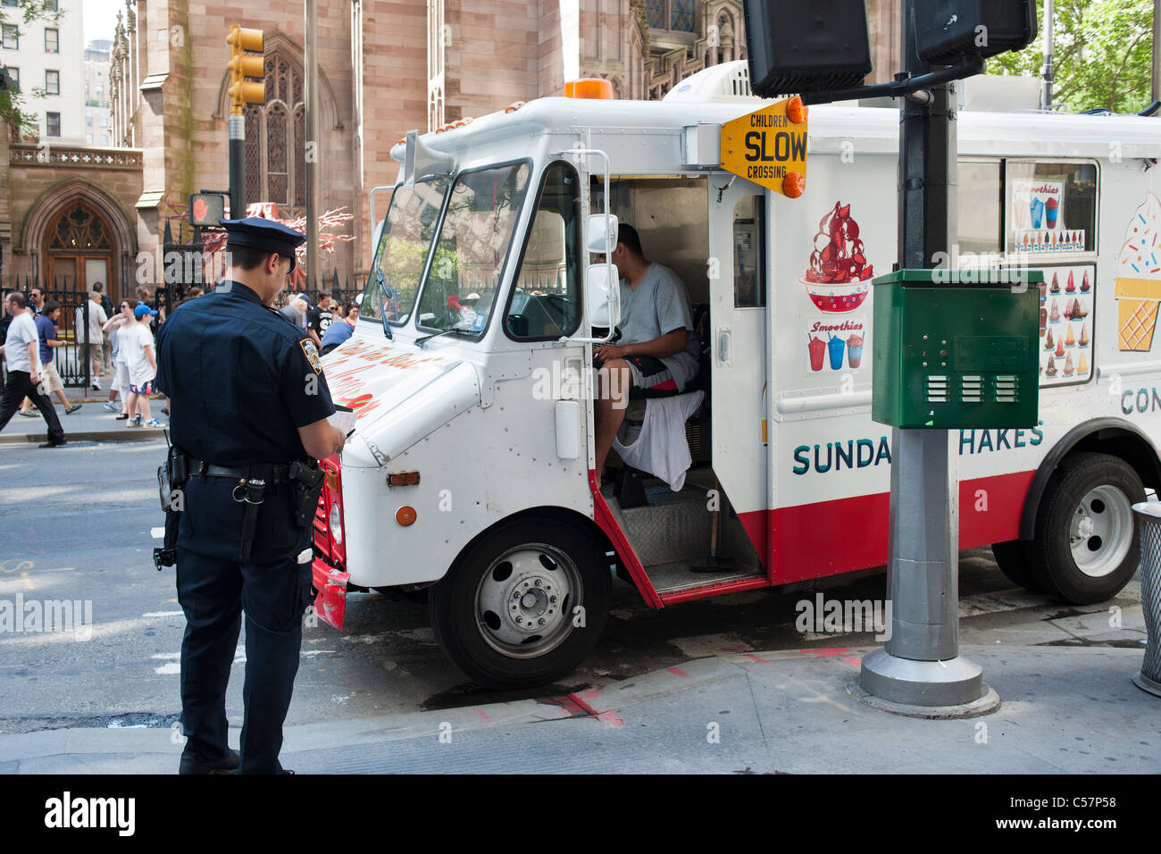An NYPD officer tickets a soft ice cream truck on Broadway in Lower ...