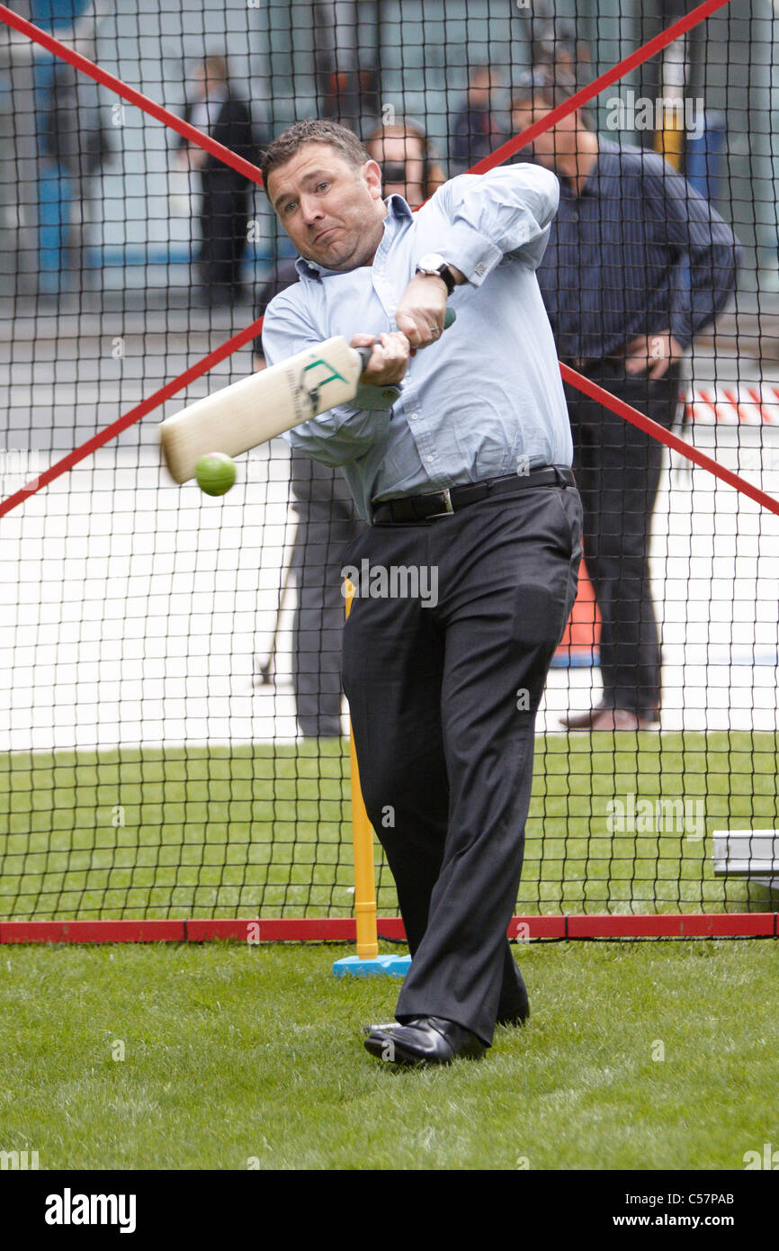 Devon Malcolm bowls at office workers in Canary Wharf, London, to ...
