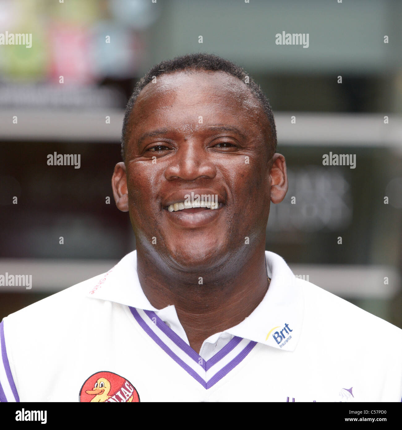 Devon Malcolm bowls at office workers in Canary Wharf, London, to ...
