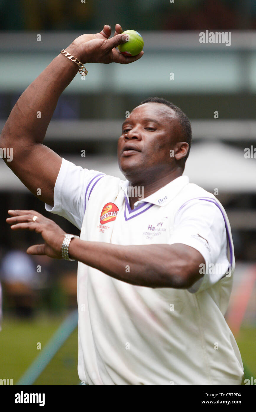 Devon Malcolm bowls at office workers in Canary Wharf, London, to ...