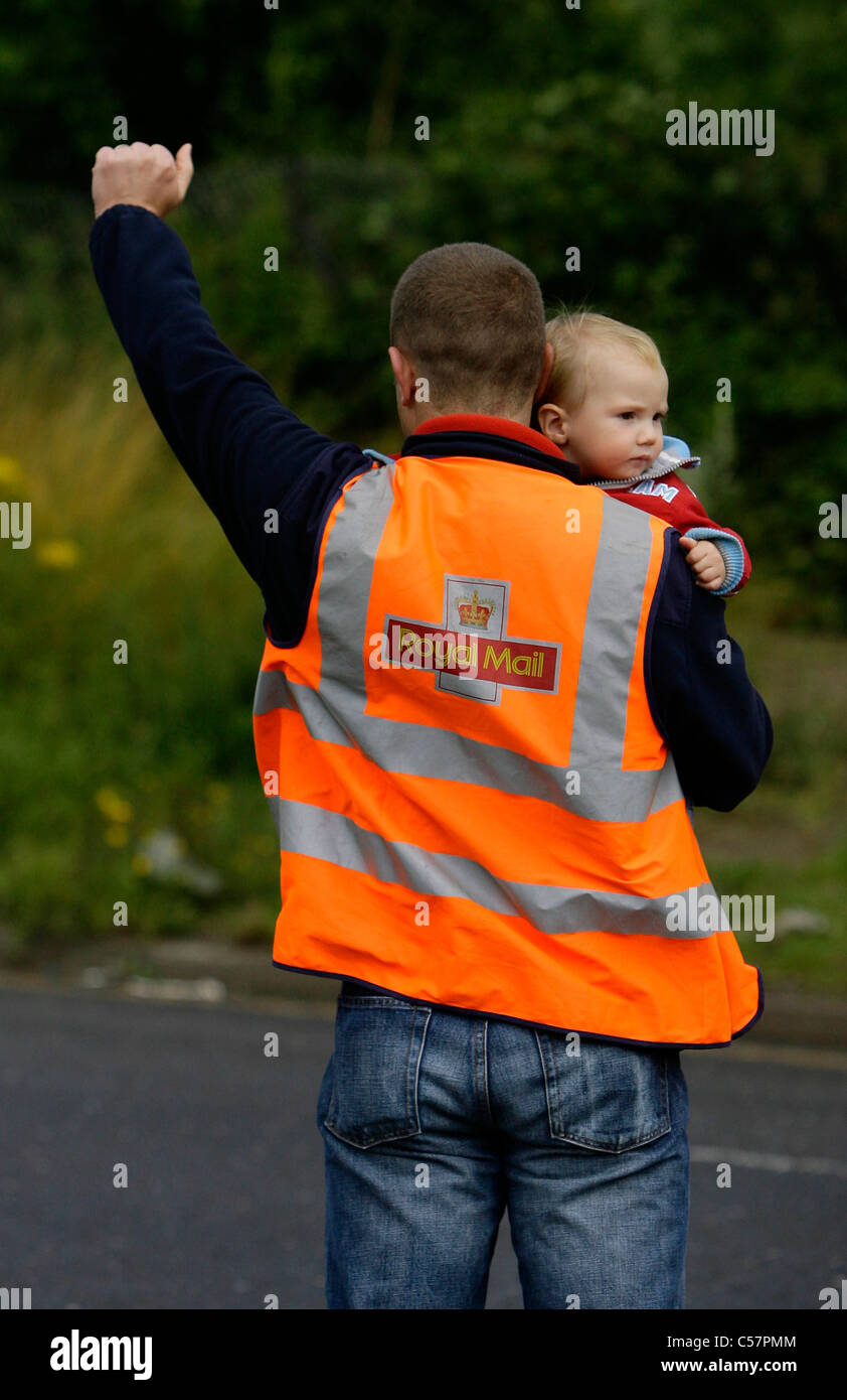 A striking postal worker with his baby. Picture by James Boardman Stock ...