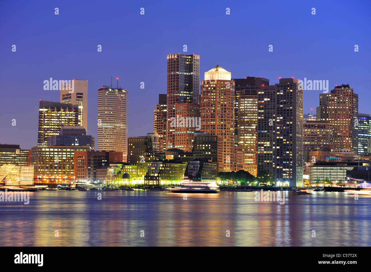 Boston downtown at dusk with urban buildings illuminated at dusk after ...