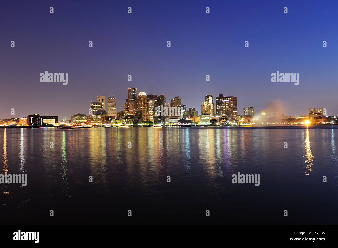 Boston downtown at dusk with urban buildings illuminated at dusk after ...