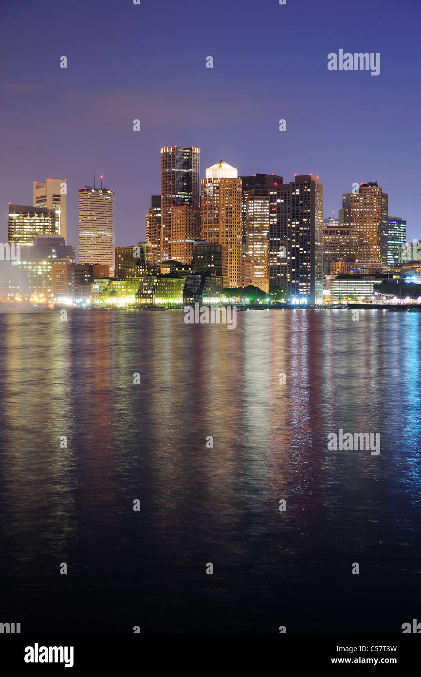 Boston downtown at dusk with urban buildings illuminated at dusk after ...
