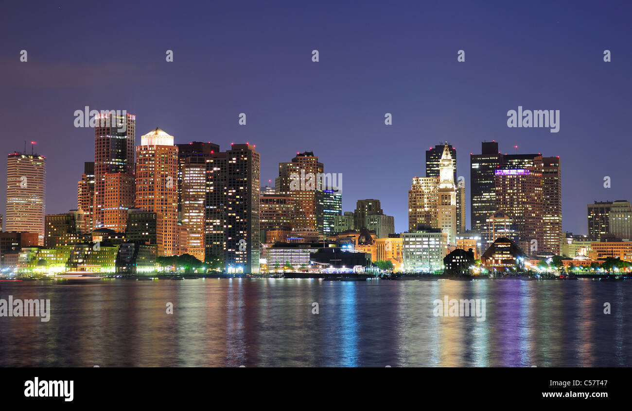 Boston downtown at dusk with urban buildings illuminated at dusk after ...
