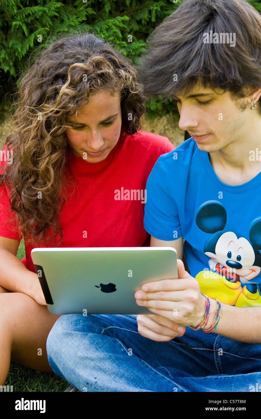 Boy and girl with Ipad Stock Photo - Alamy