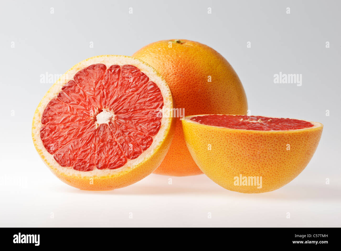 Pink grapefruit against a plain background Stock Photo - Alamy