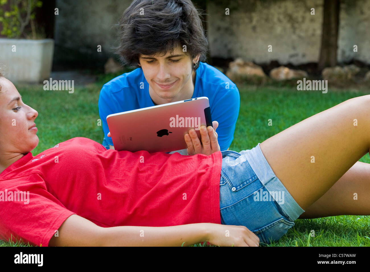 Boy and girl with Ipad Stock Photo - Alamy