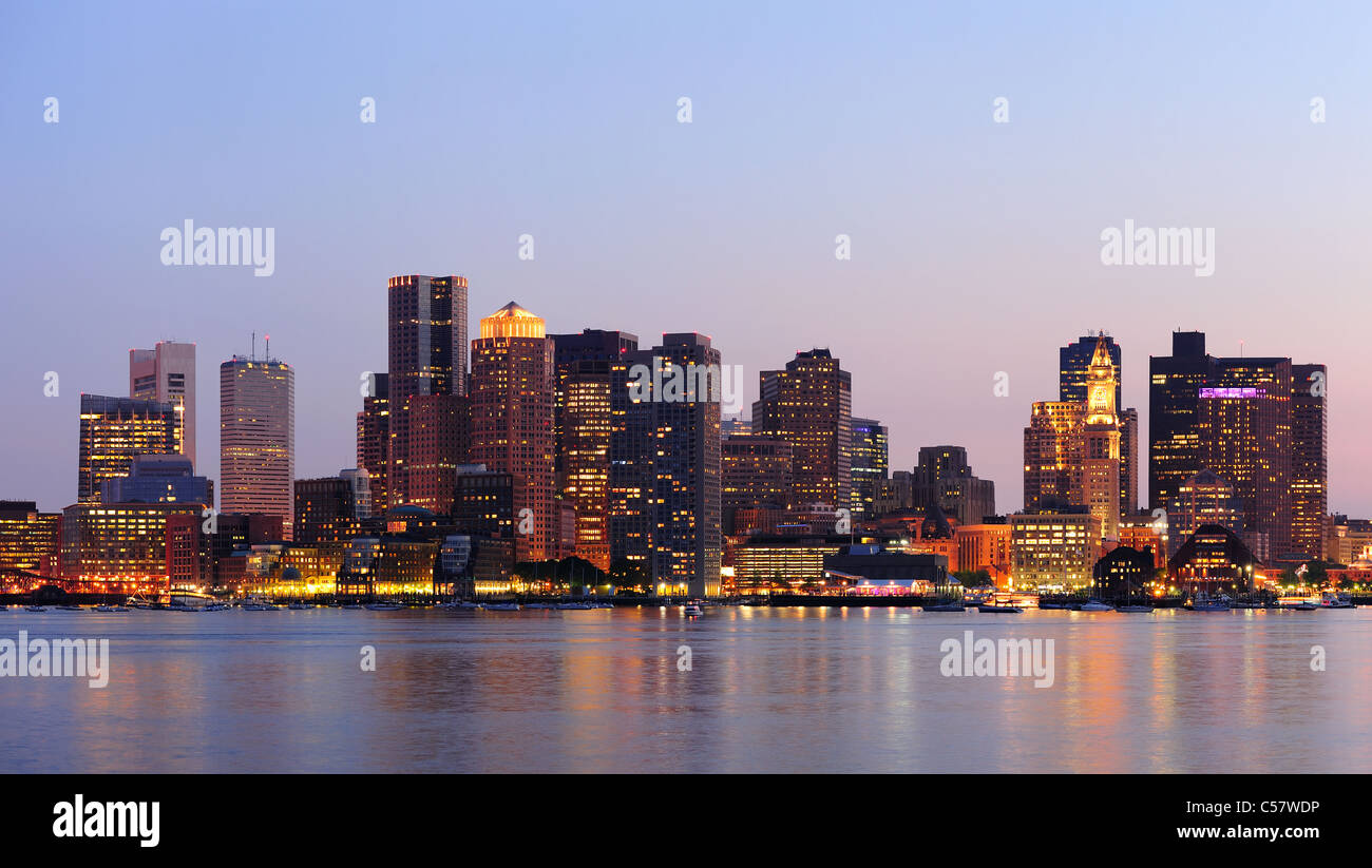 Boston downtown at dusk with urban buildings illuminated at dusk after ...