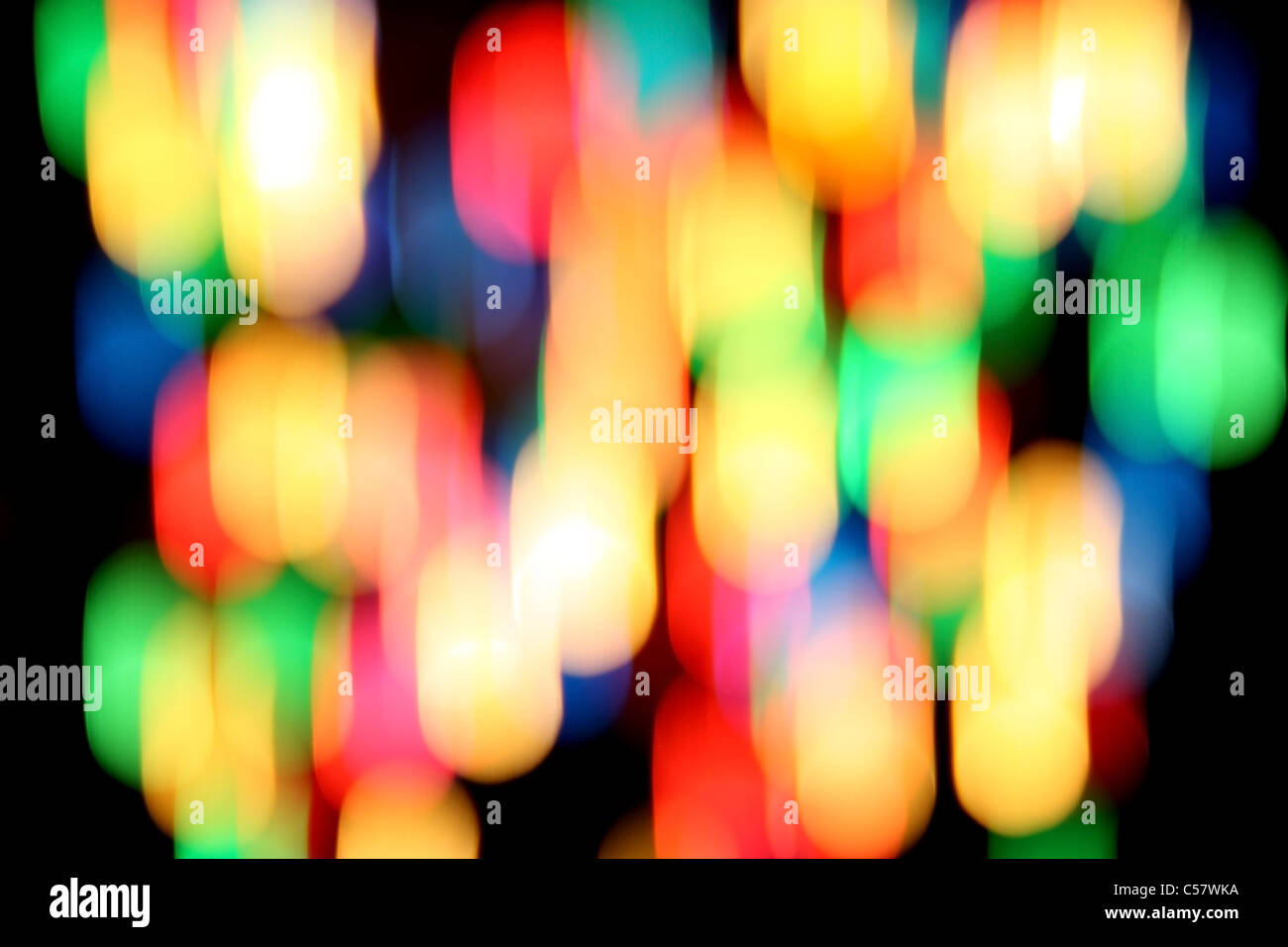Multicolored spots of light against a black background Stock Photo - Alamy