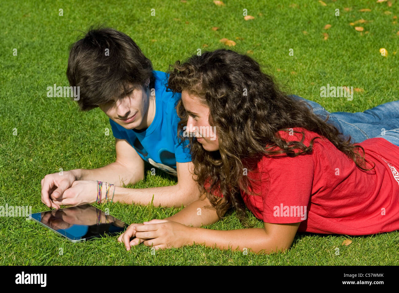 Boy and girl with Ipad Stock Photo - Alamy