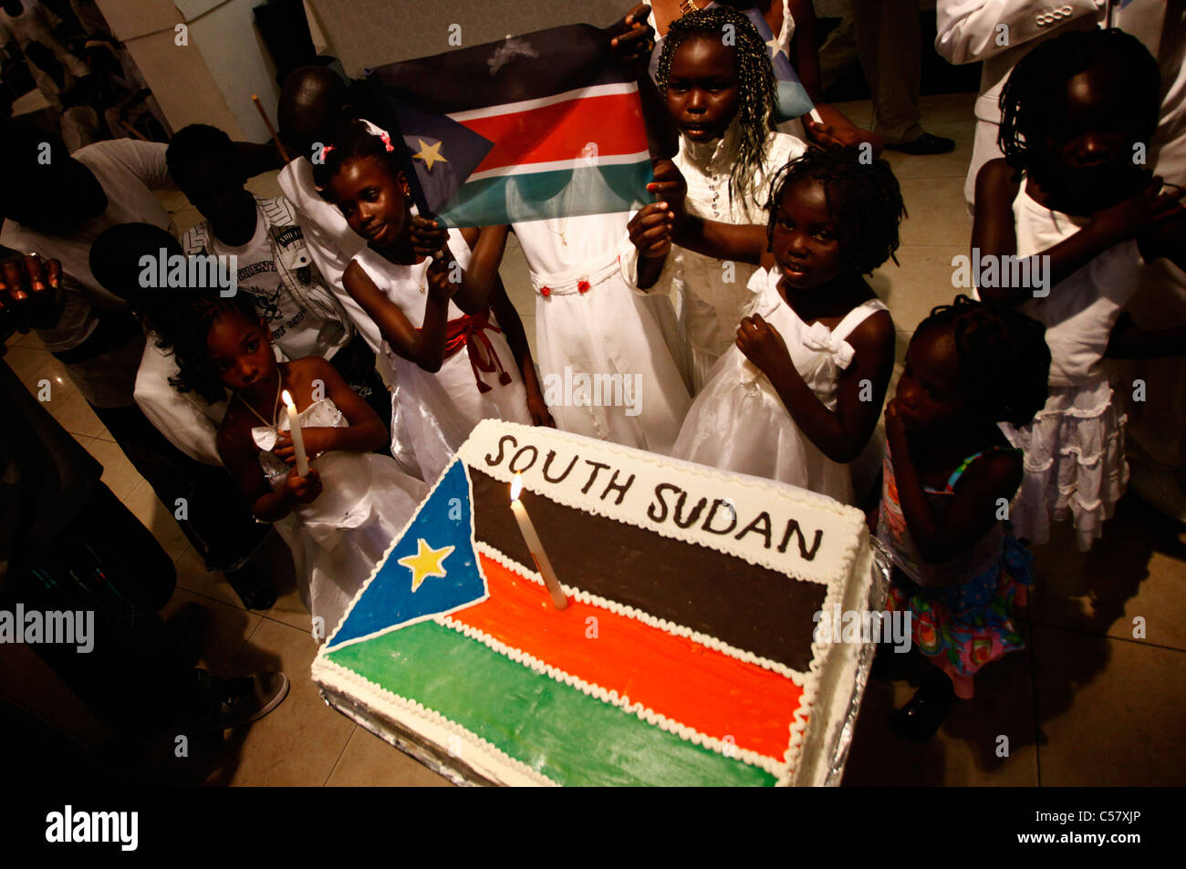South Sudanese children celebrate with a Republic of South Sudan flag ...