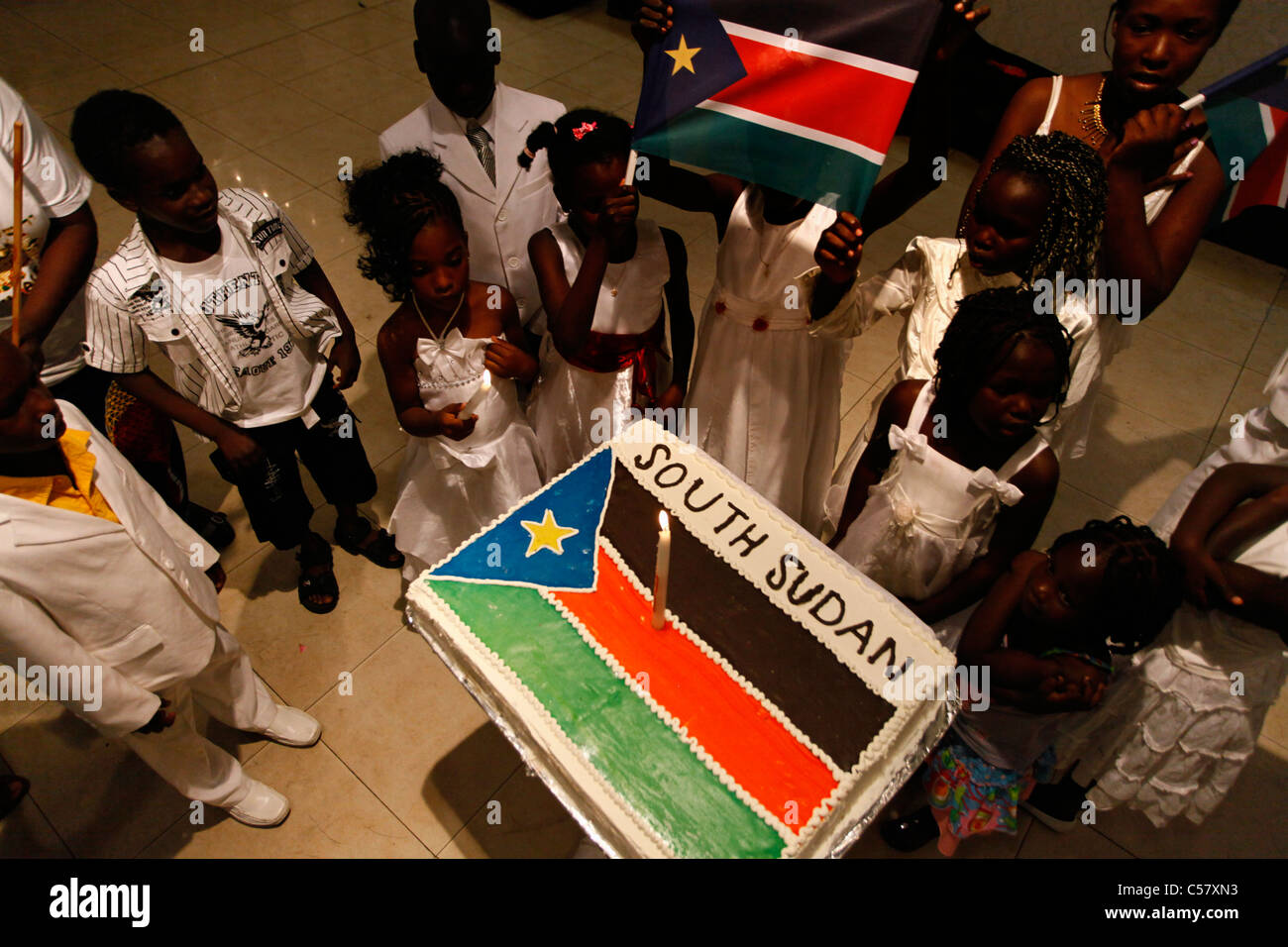 South Sudanese children celebrate with a Republic of South Sudan flag ...