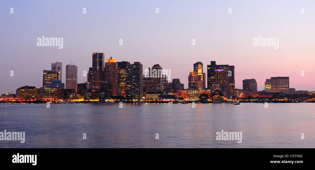 Boston downtown at dusk with urban buildings illuminated at dusk after ...