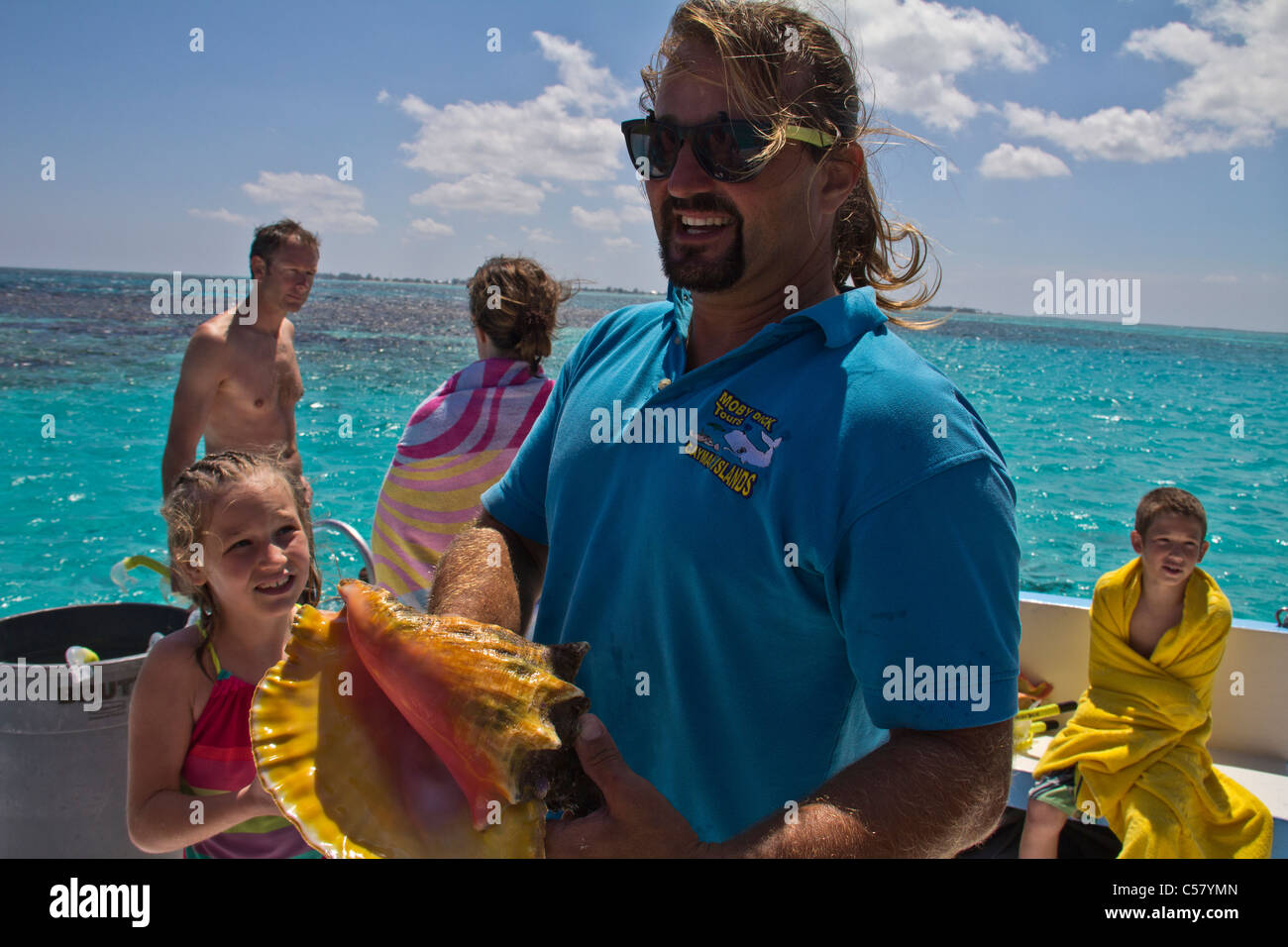 People interact with the stingrays at Stingray City, Cayman Islands ...
