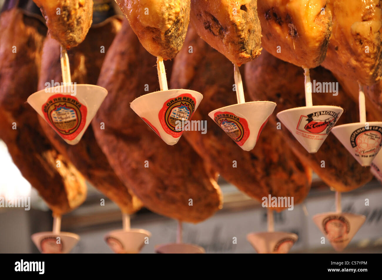 Iberian Serrano ham hanging up Stock Photo - Alamy