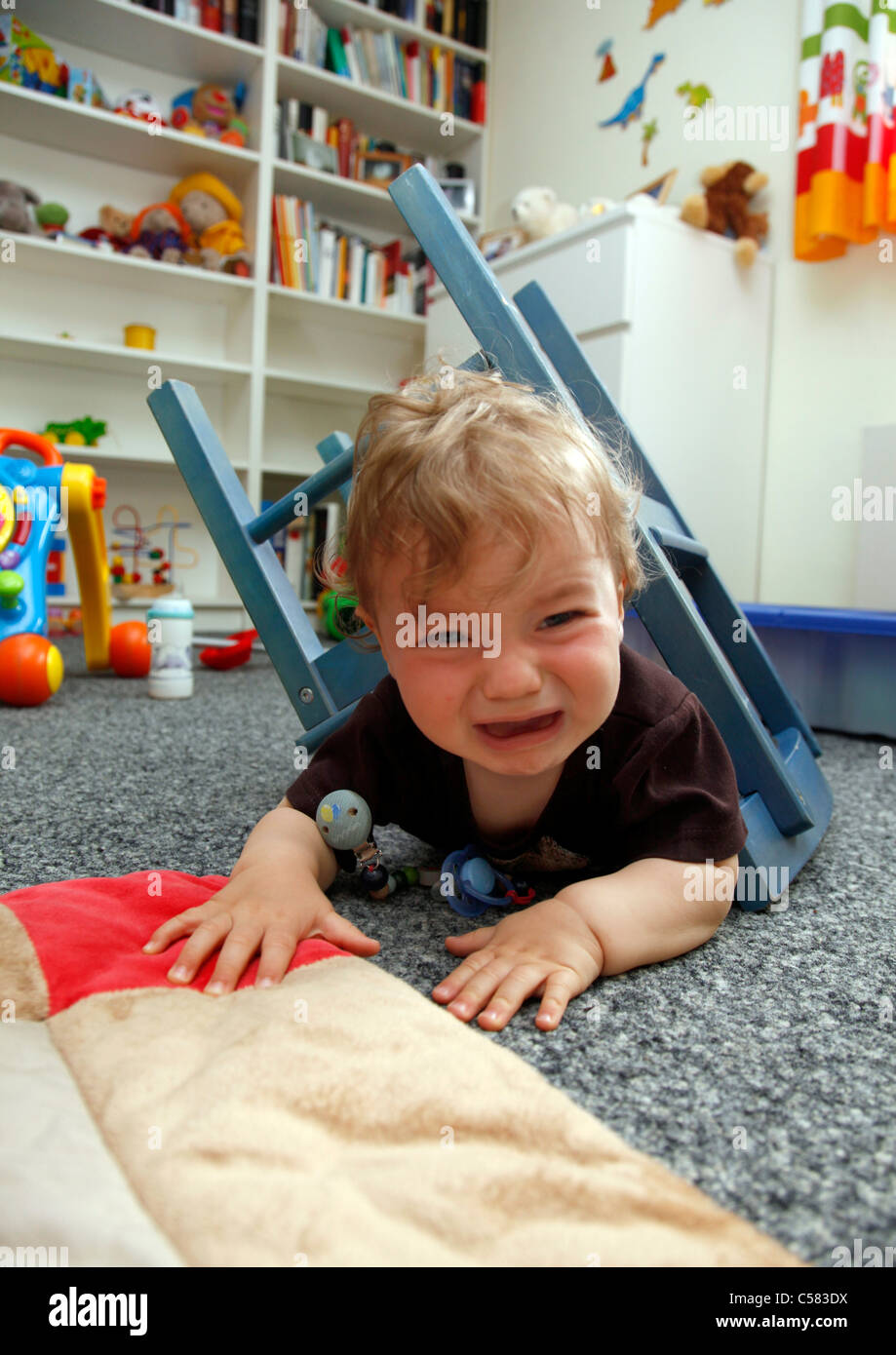 Little boy, one year old. At home.Crying, after crashing with a ...