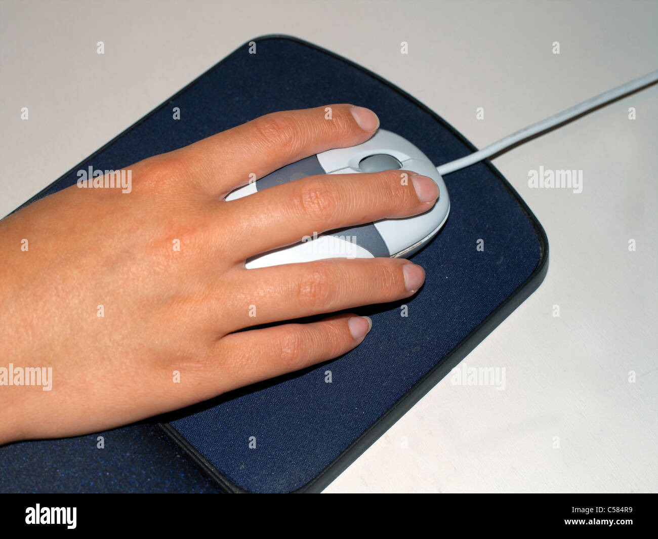 Hand on Computer Mouse and Mouse Mat Stock Photo - Alamy