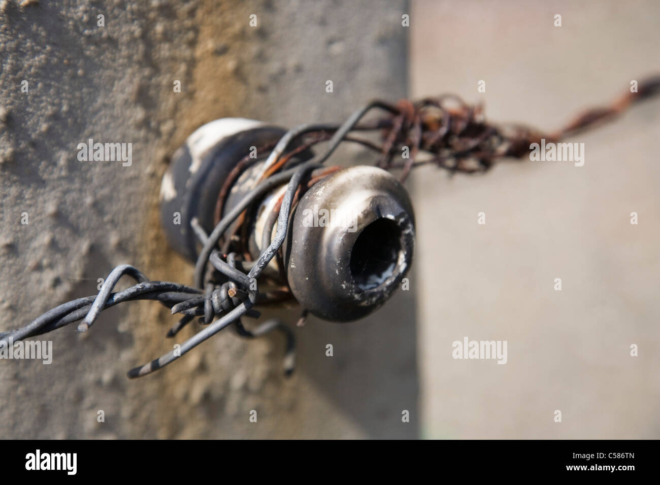 An insulating point, electrofied barbed wire is attached onto a ...