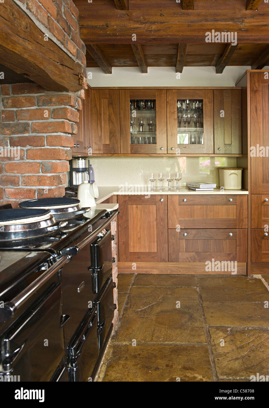 Traditional farmhouse kitchen with flagstone floor, timber beams and ...