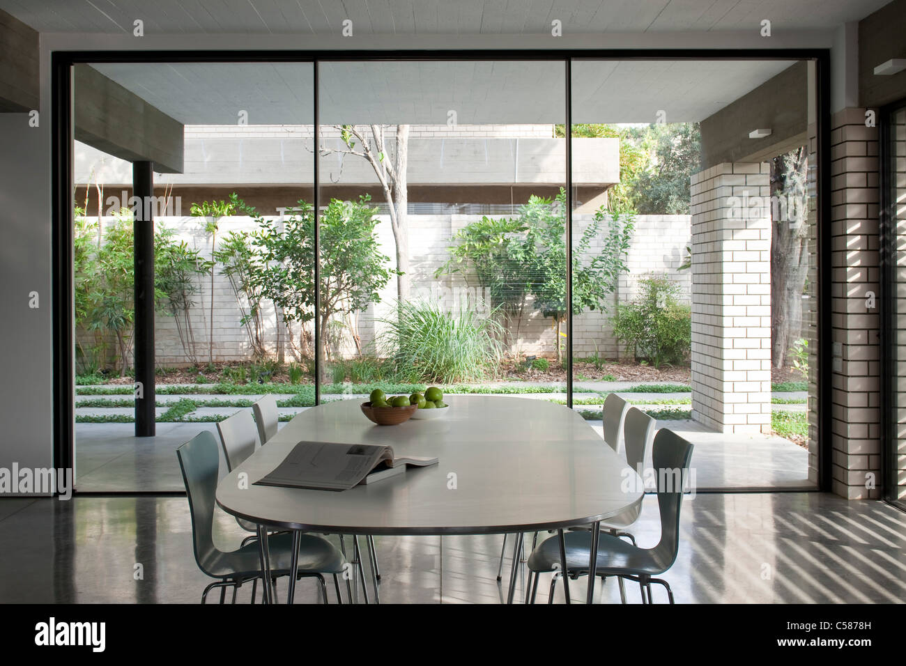 Dining area and view out to landscaped garden in a modern house Stock ...
