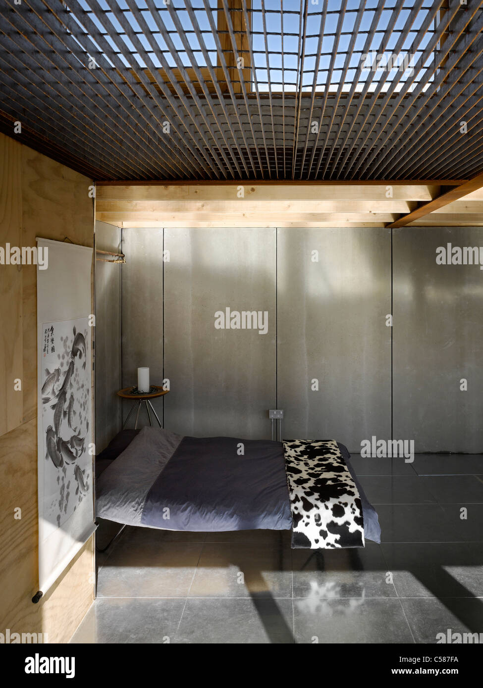 Modern bedroom in an open plan living space Stock Photo - Alamy