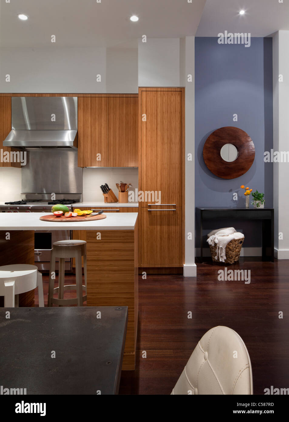 View over custom made dining room table to bamboo millwork in kitchen ...