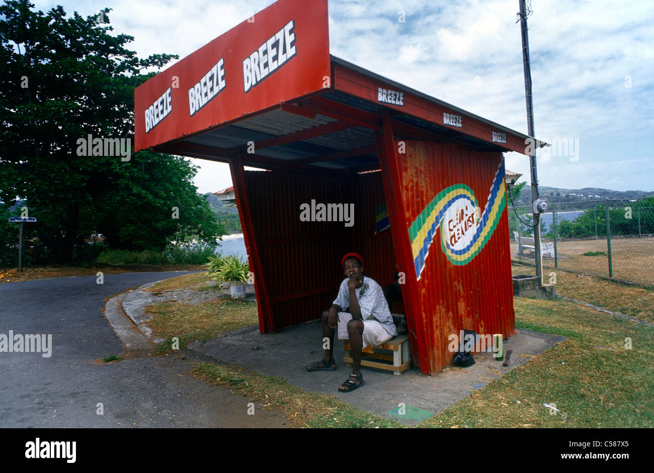 Plymouth Tobago Man Sitting Under Bus Shelter Waiting At Bus Stop Stock ...