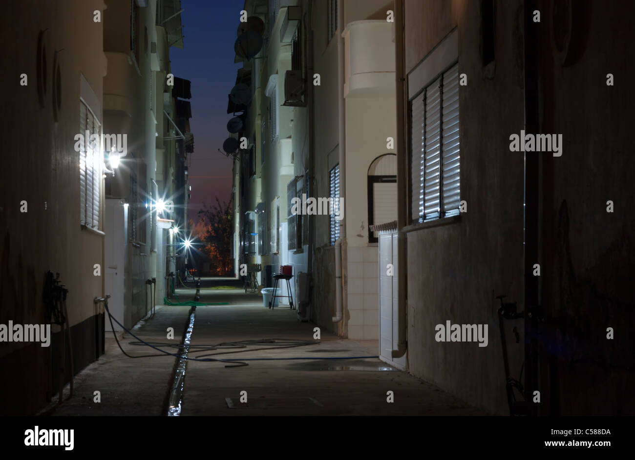 Looking down an alleyway at night Stock Photo - Alamy