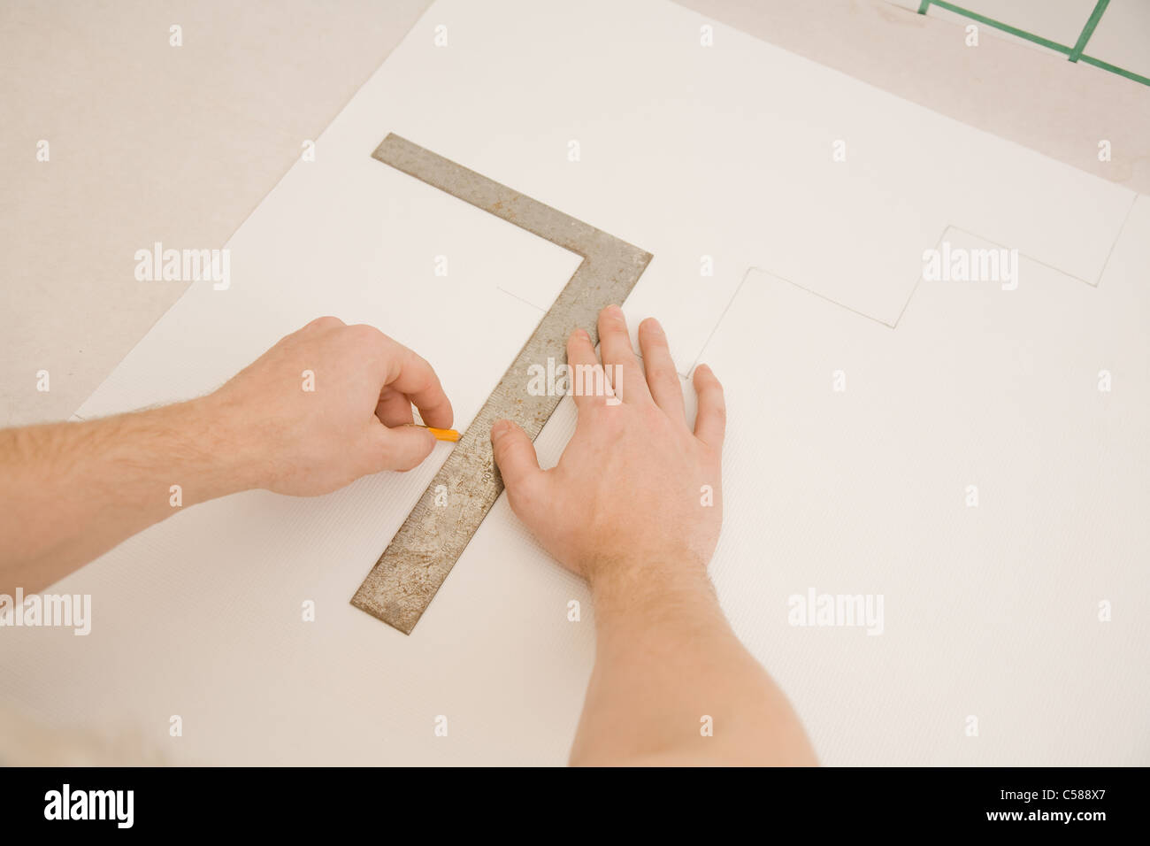 Hands with ruler and pen drawing line Stock Photo - Alamy