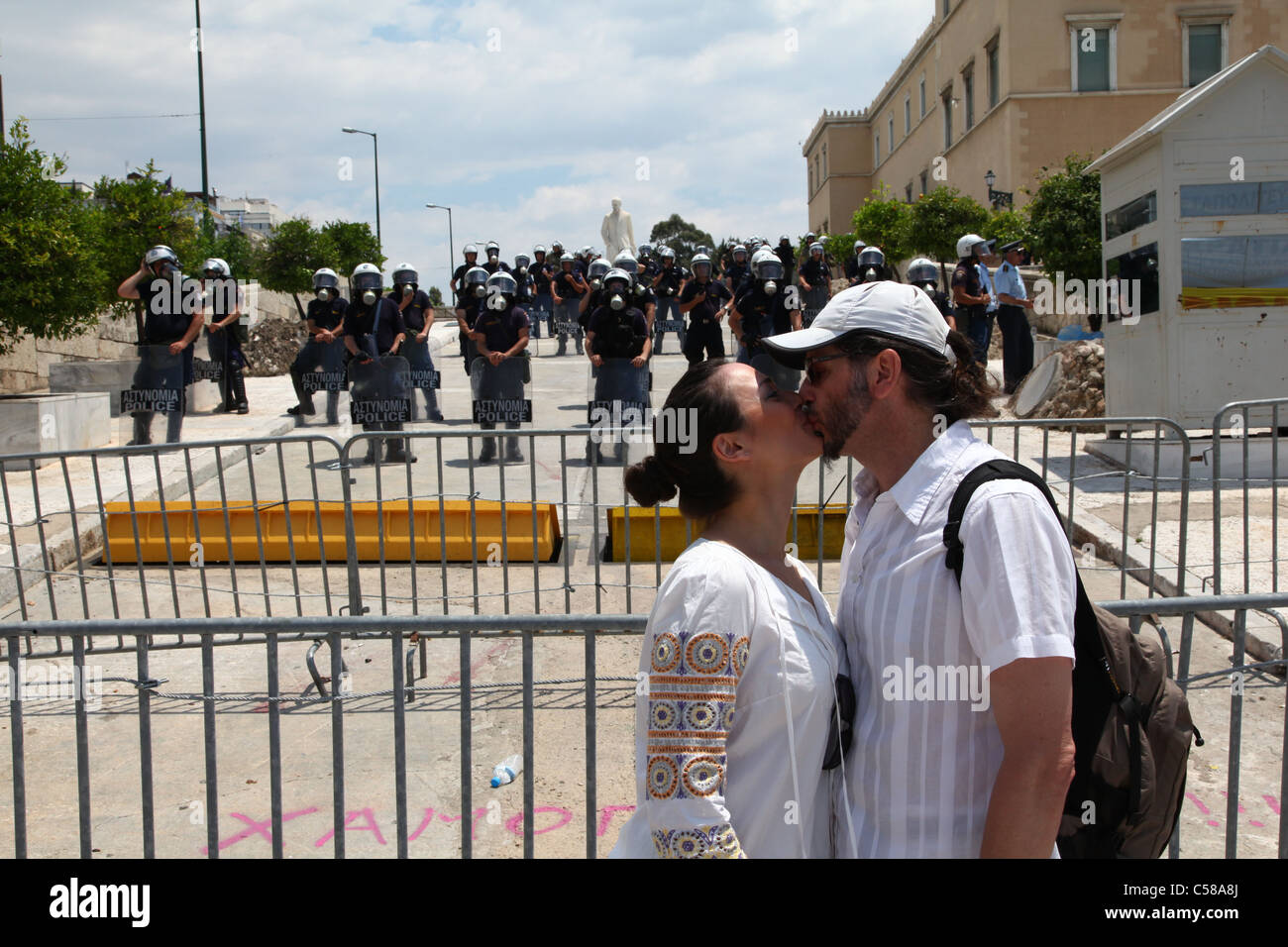 Greece, couple kissing in front of riot police Stock Photo - Alamy