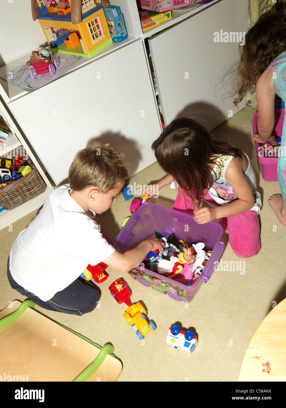 Children Playing With A Box Of Toys England Stock Photo - Alamy