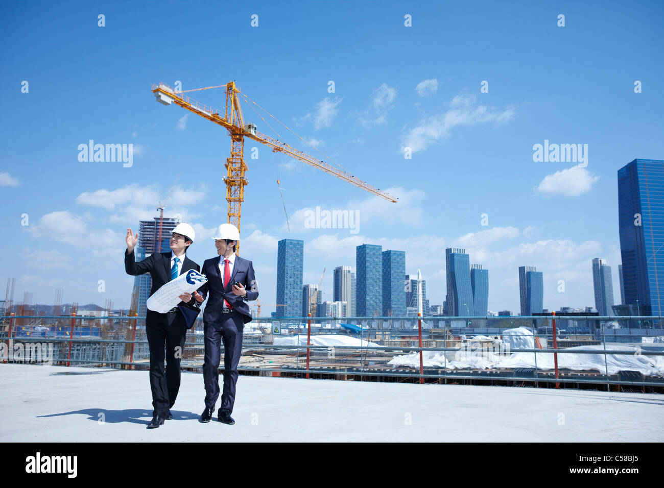 business people walking at construction site Stock Photo - Alamy