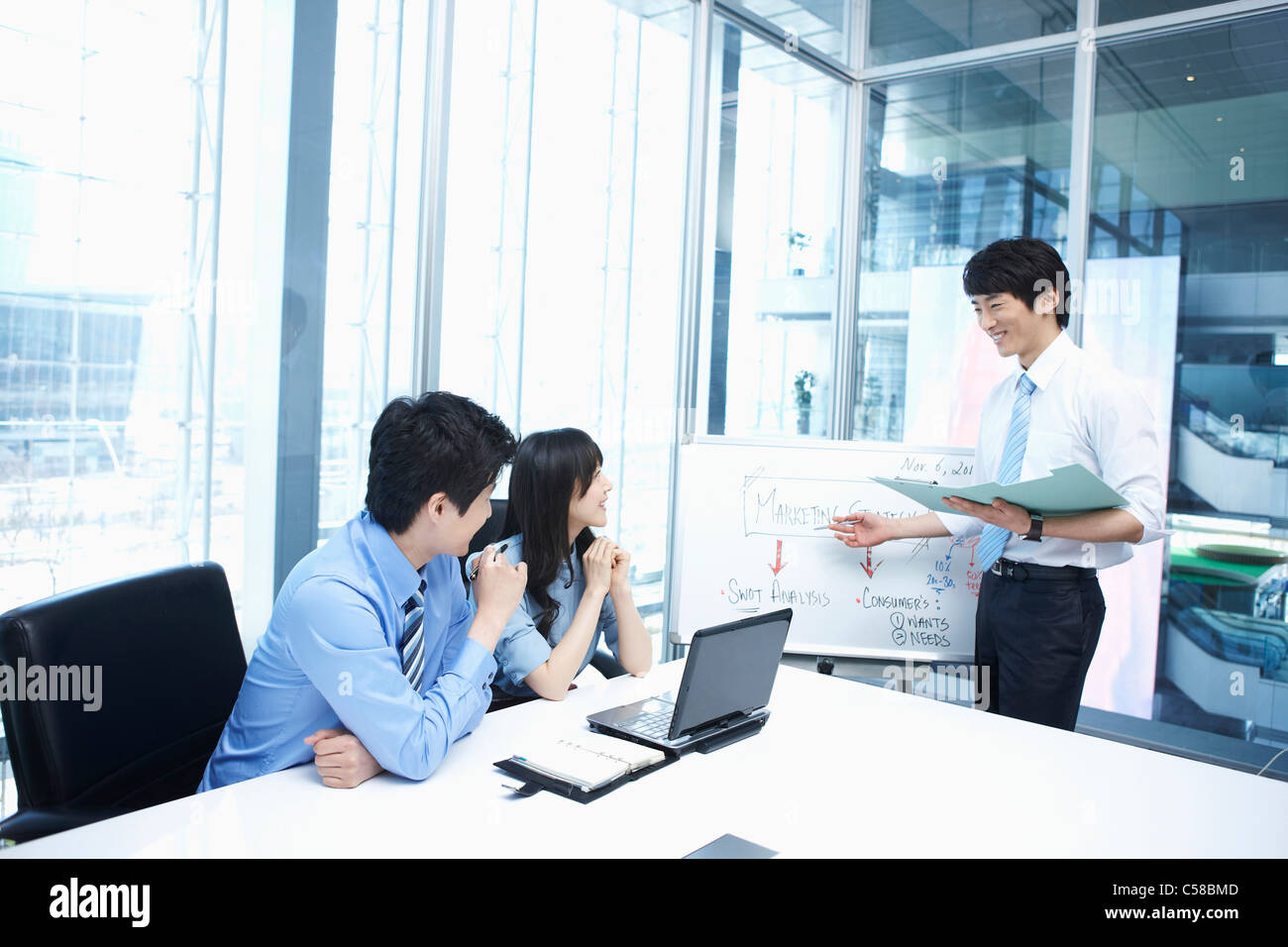 woman doing presentation to people in meeting room Stock Photo - Alamy