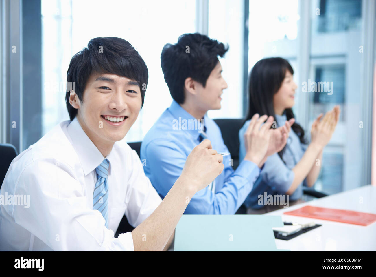 people clapping hands together in meeting room Stock Photo - Alamy