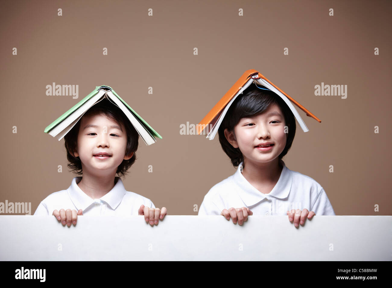 children balancing a book on their head Stock Photo - Alamy