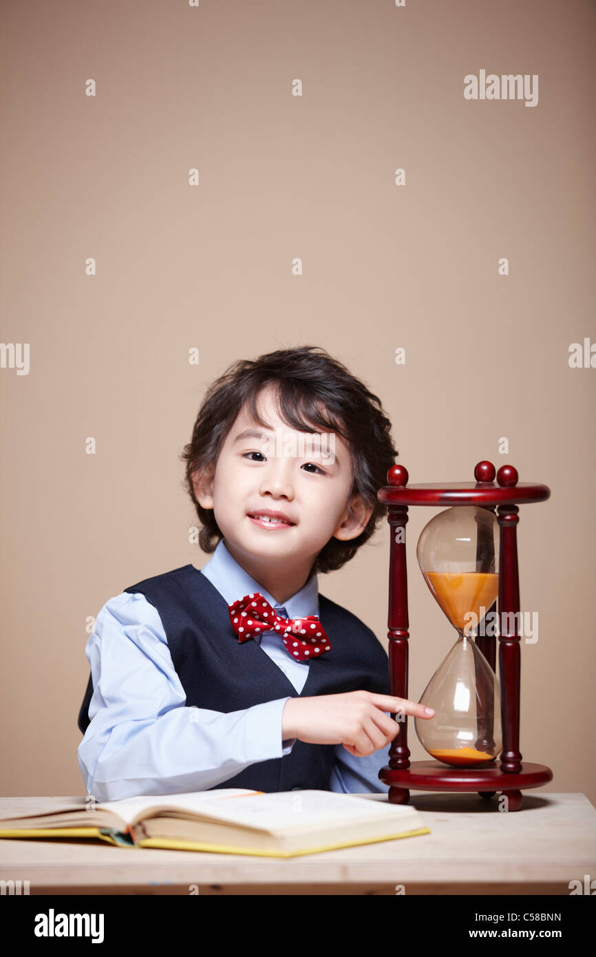 boy pointing at sandclock Stock Photo - Alamy