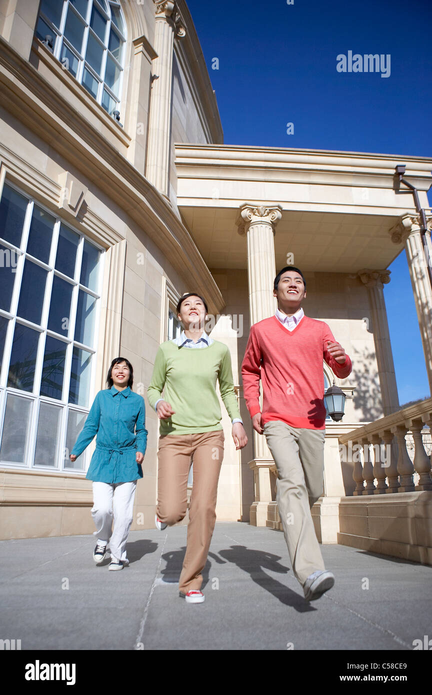 Teens running in college Stock Photo - Alamy