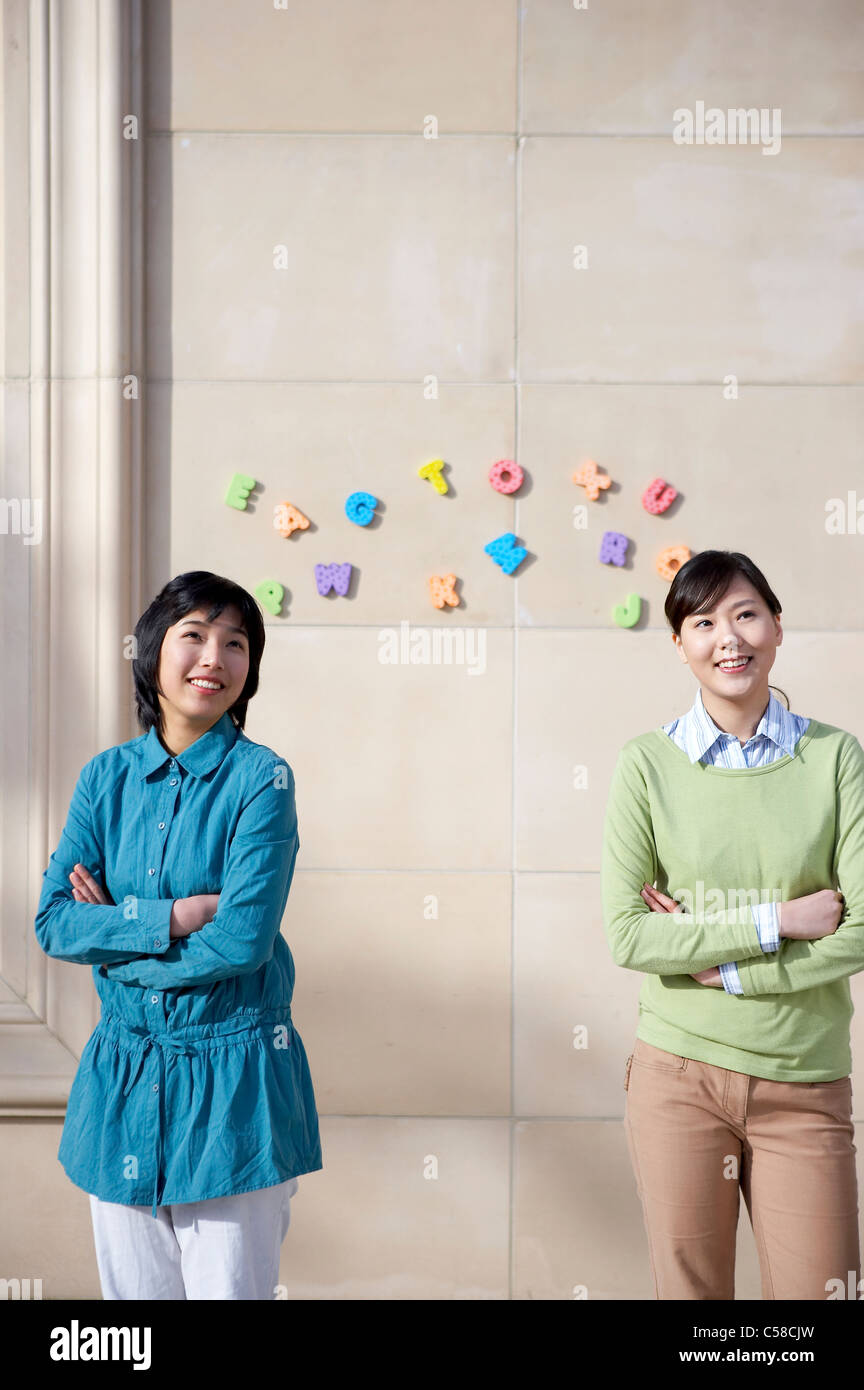 Teens standing by wall Stock Photo - Alamy