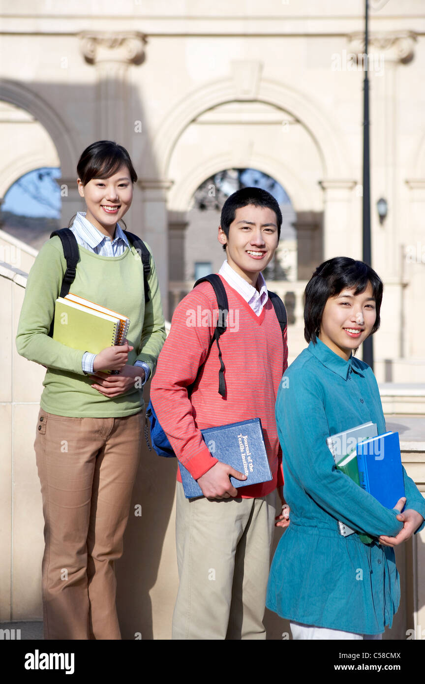 Portrait of teens standing in college Stock Photo - Alamy