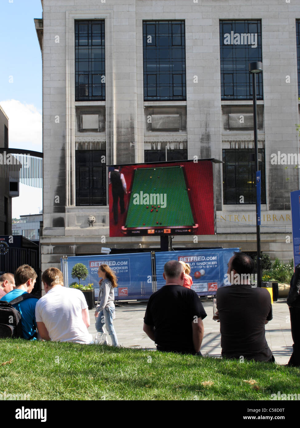 People watching snooker on a large screen outdoors in Sheffield city ...