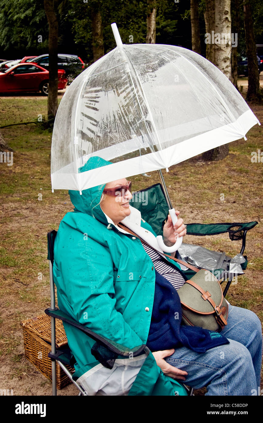 Woman with umbrella at a picnic in the rain Stock Photo - Alamy