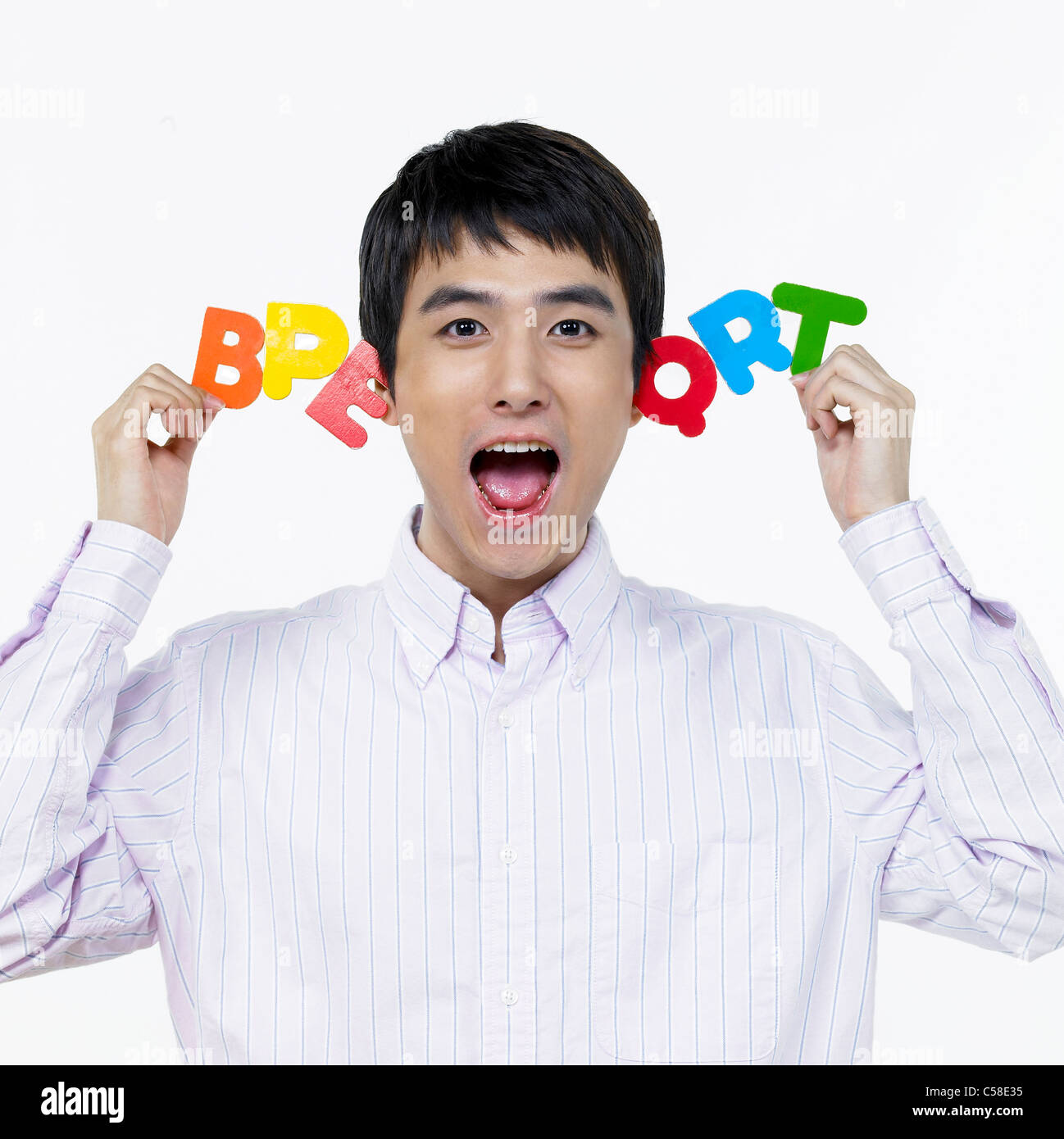 Portrait of teenage boy holding alphabet Stock Photo - Alamy