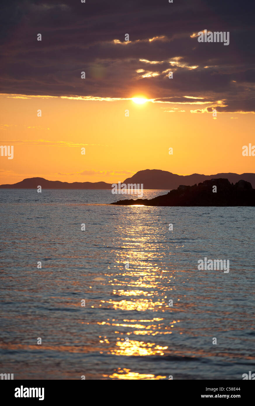 Sunset over the Scottish Isles as seen from Camusdarach in the Western ...
